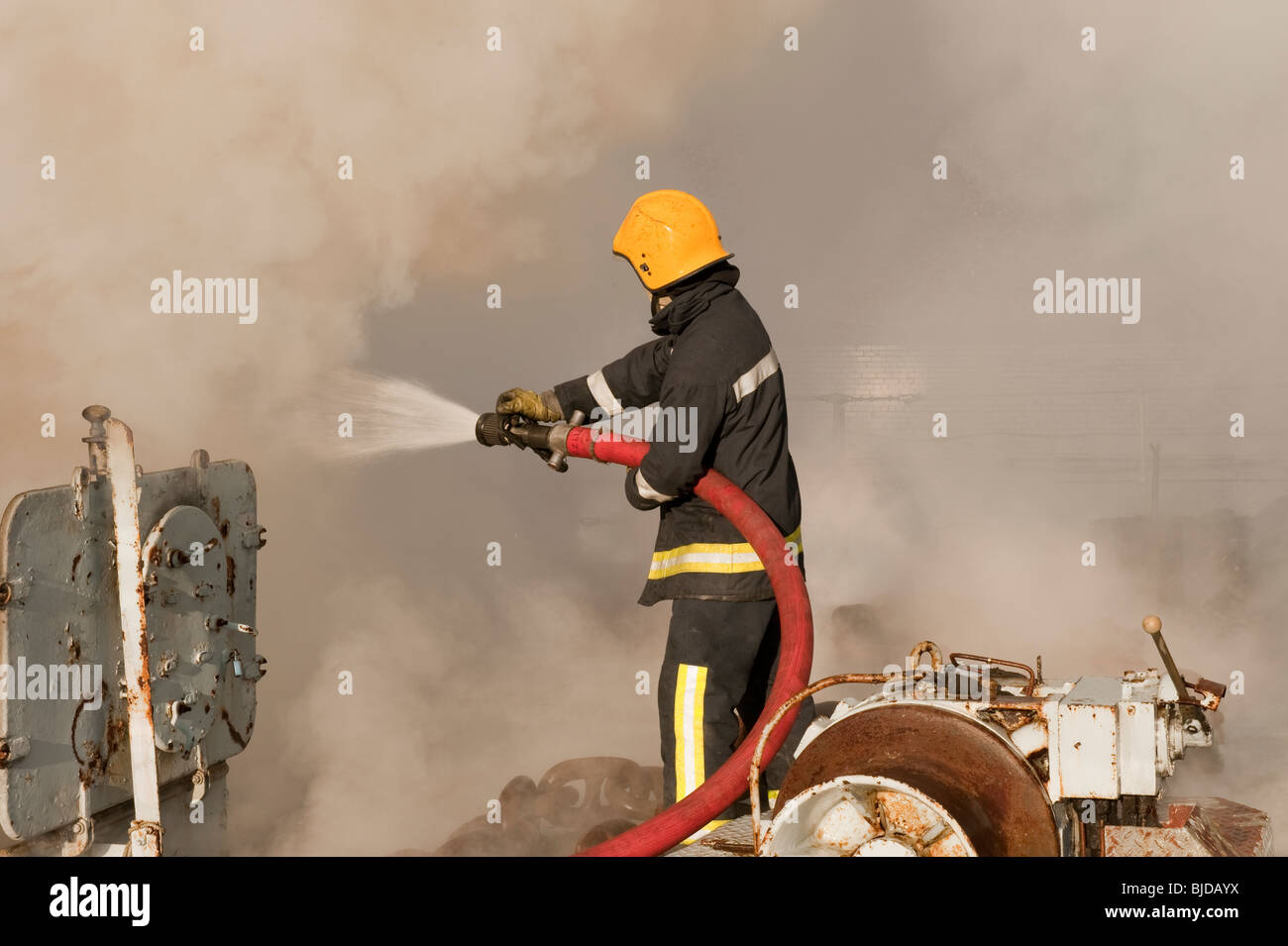 Firefighter using hose hi-res stock photography and images - Alamy