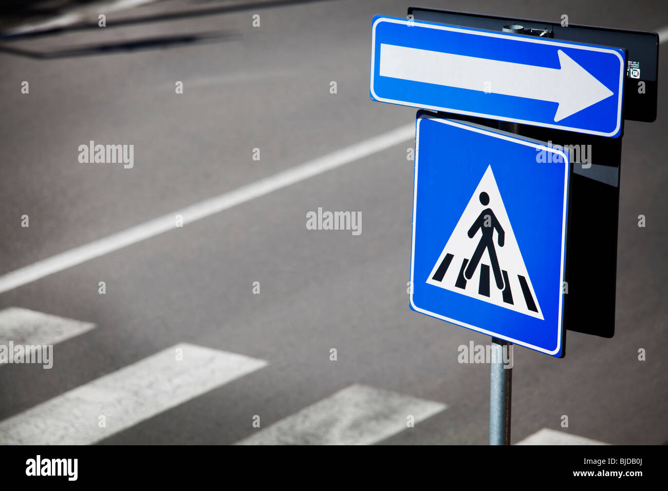 Zebra crossing street sign one way direction Stock Photo - Alamy
