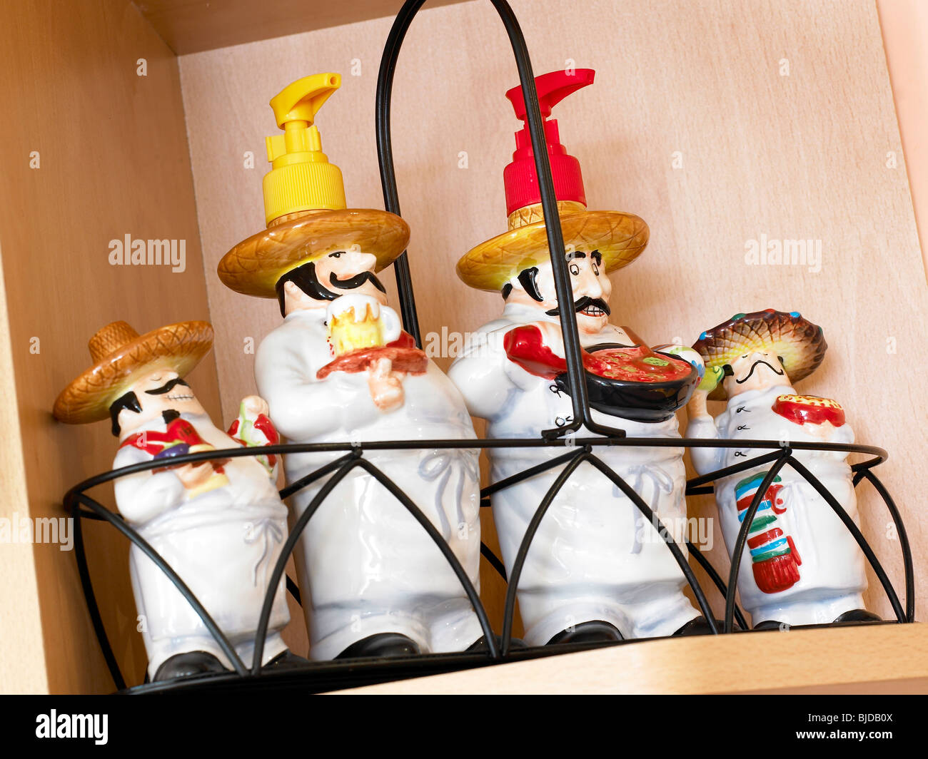 Mexican hatted chef ketchup dispensers Stock Photo - Alamy
