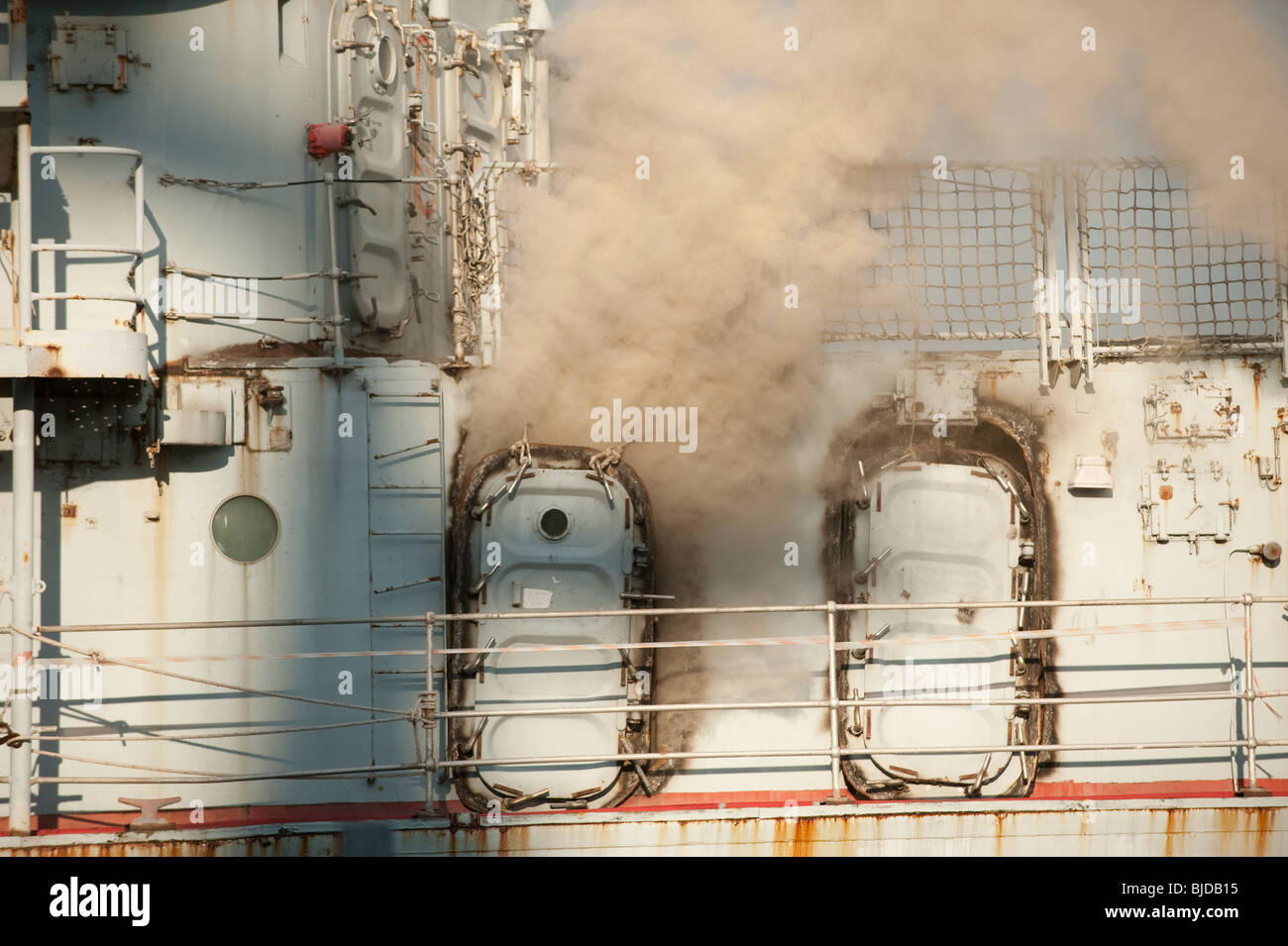 Thick smoke coming from hatch door of ship on fire Stock Photo - Alamy