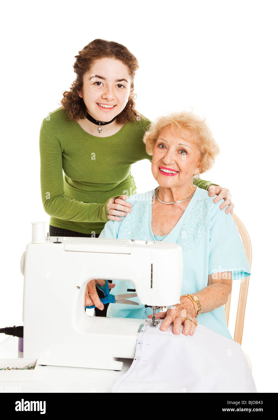 Teenage girl and her grandmother working on a sewing project together ...