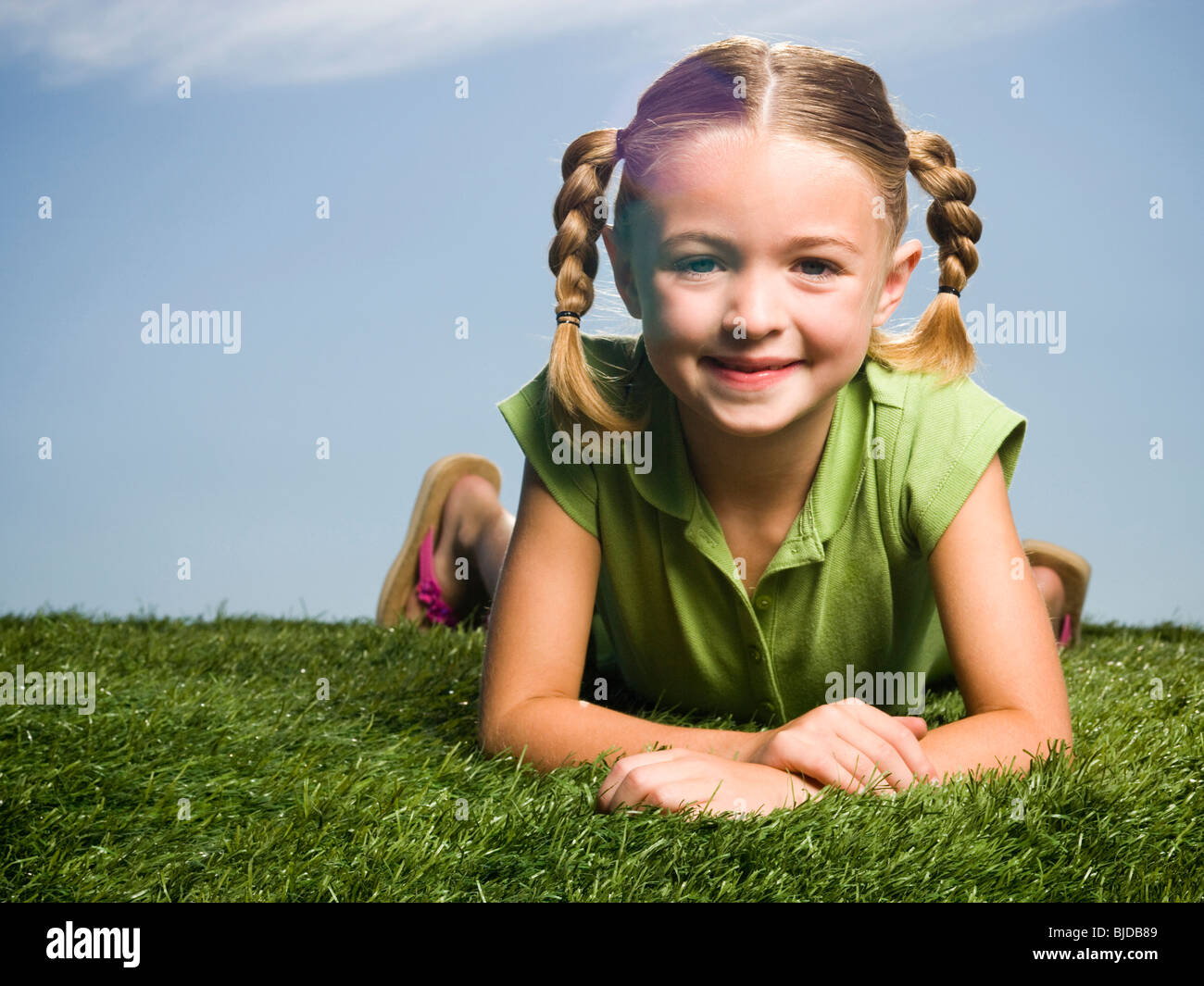 Young girl on the grass Stock Photo - Alamy