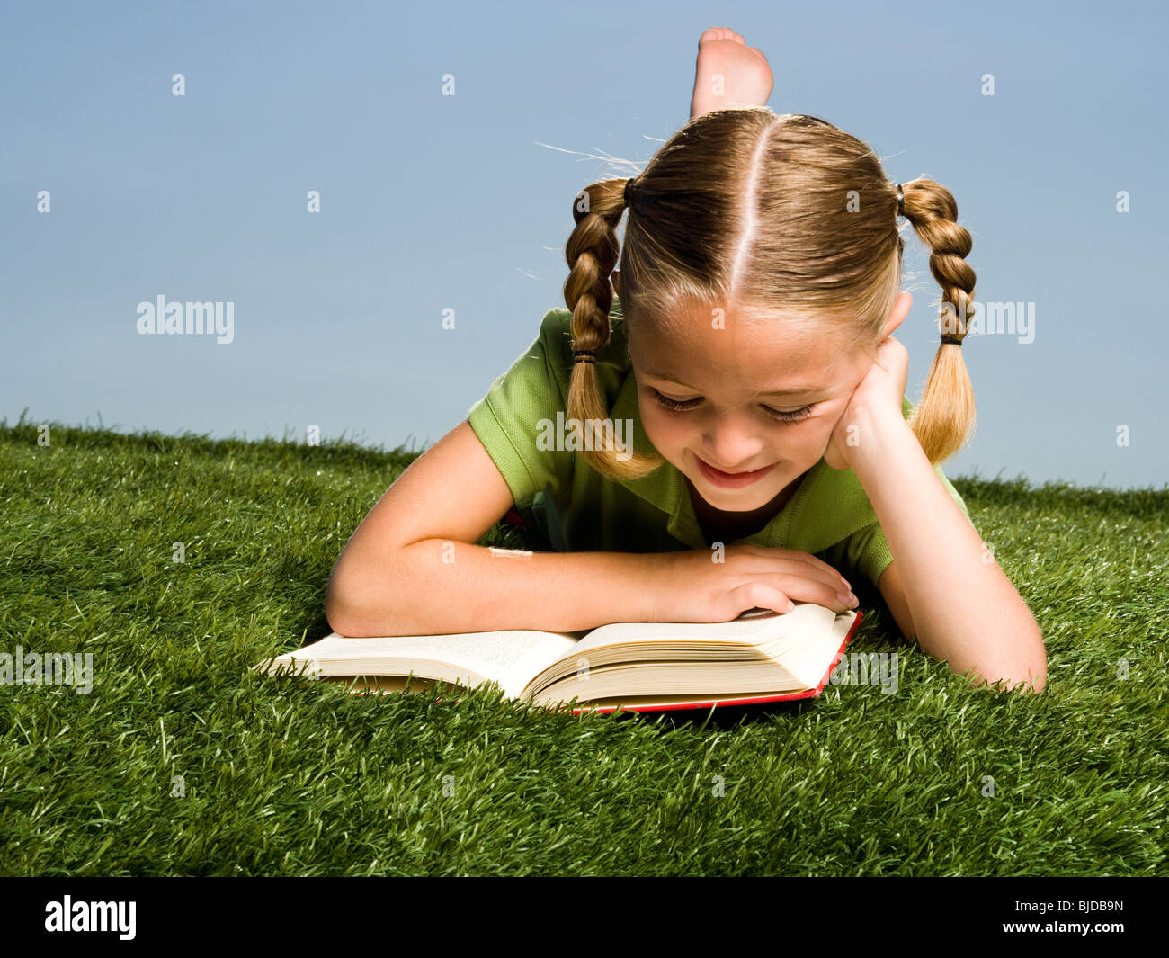 Child reading a book Stock Photo - Alamy