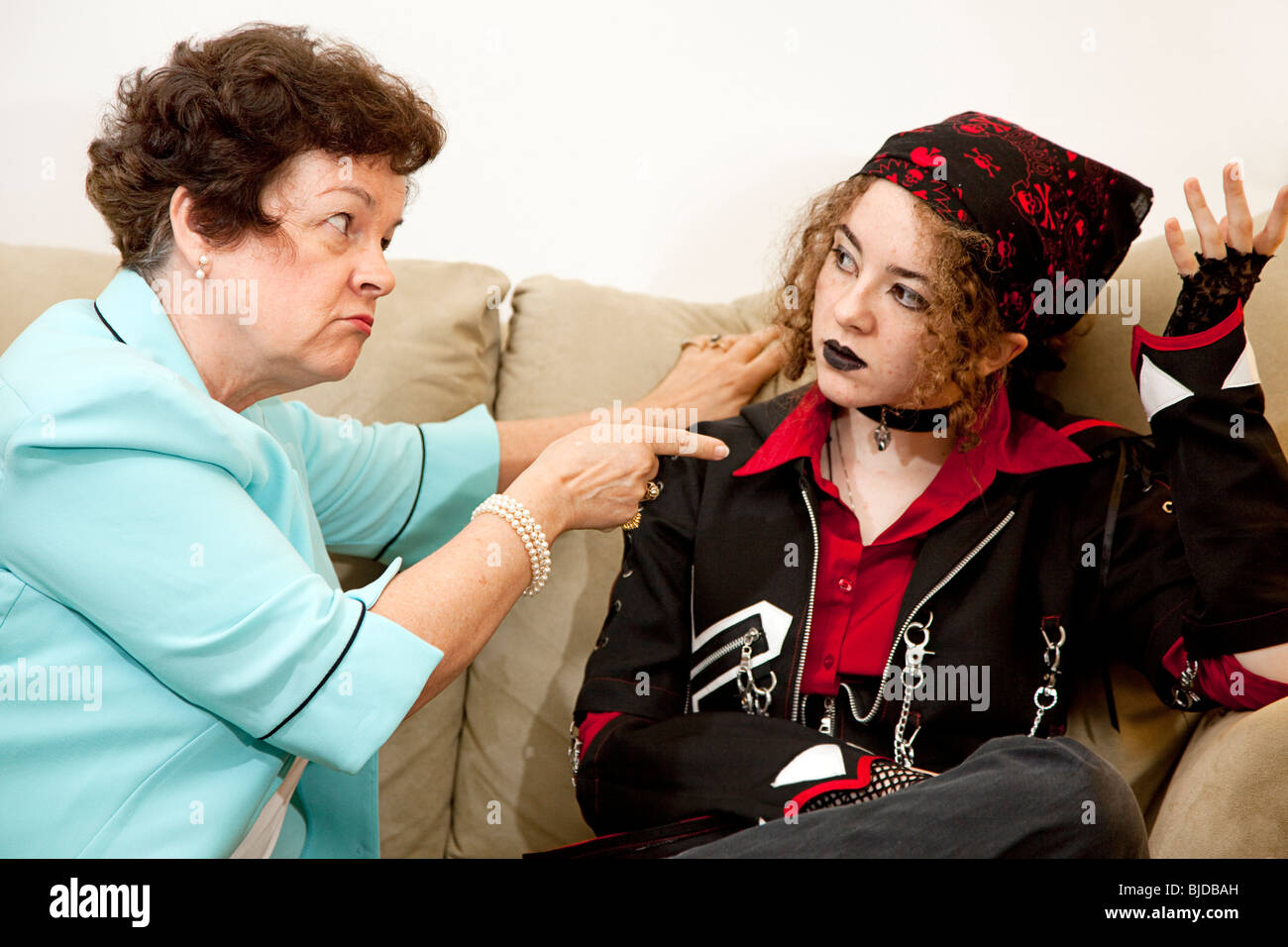 Angry mother pointing the finger at her rebellious teenage daughter ...