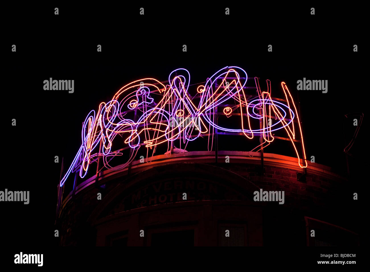 Neon sign graffiti multi colored lit up at night Stock Photo - Alamy