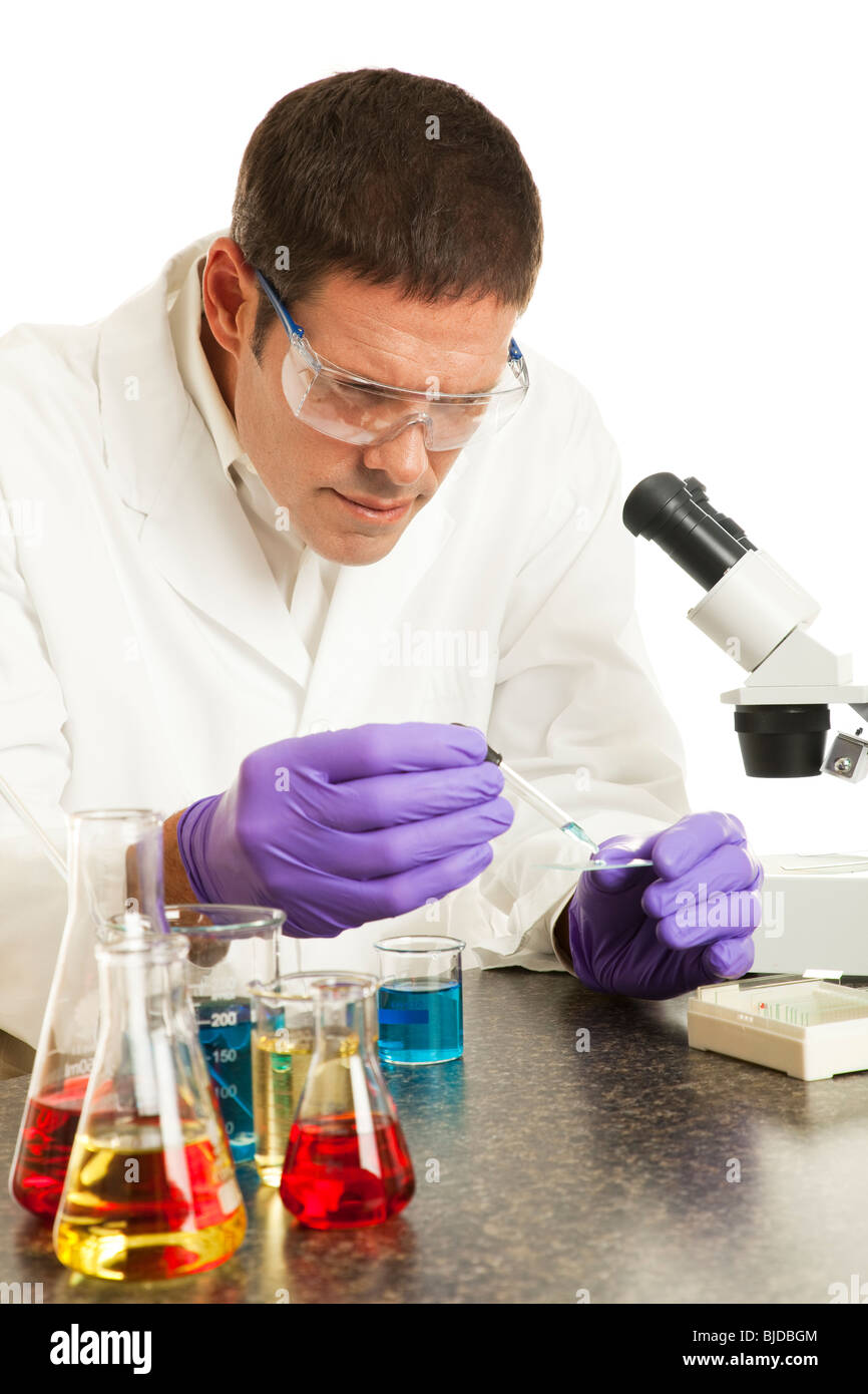 Scientist in his laboratory, preparing a slide for the microscope ...