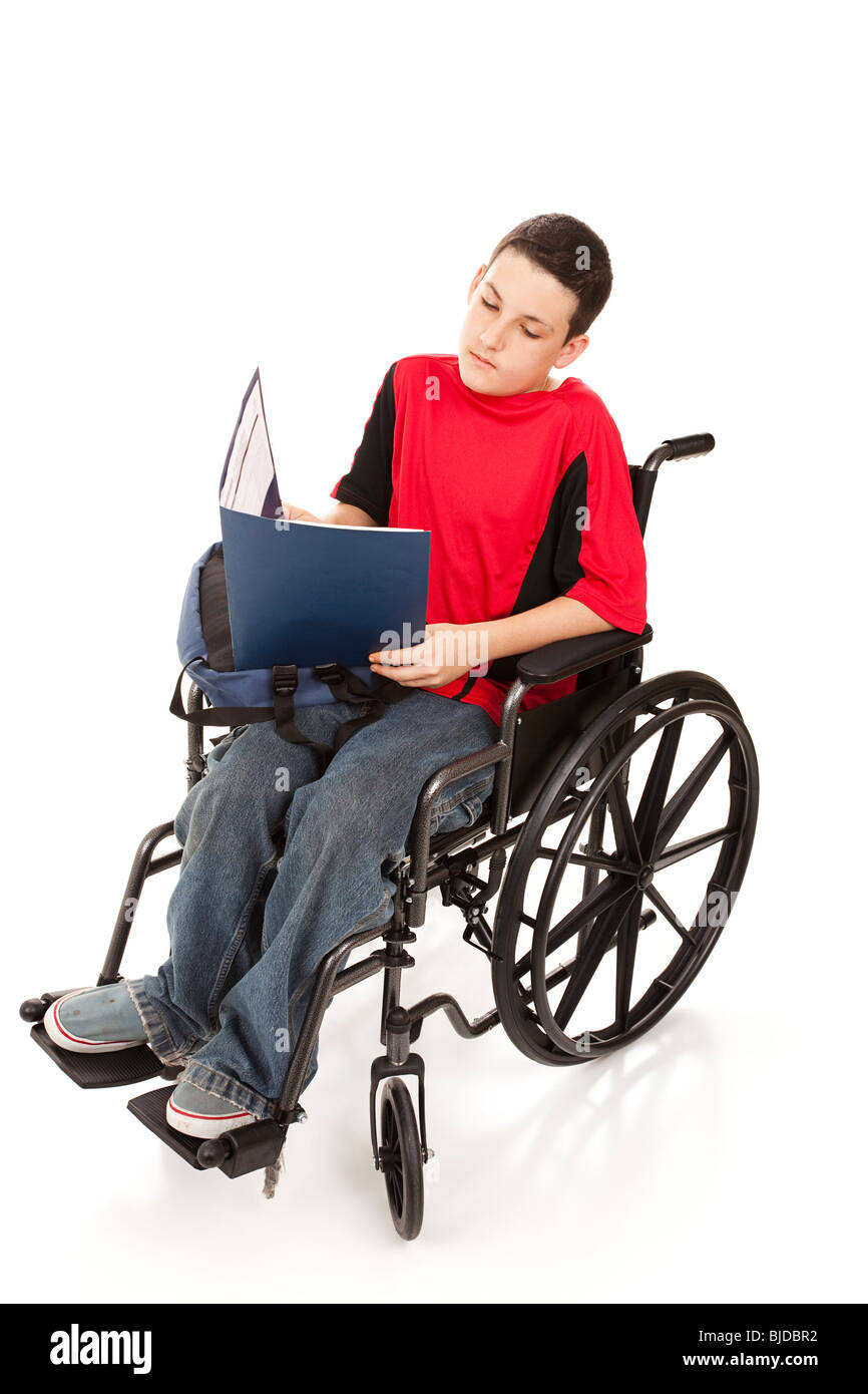 Disabled teen boy doing homework in his wheelchair. Full body isolated ...