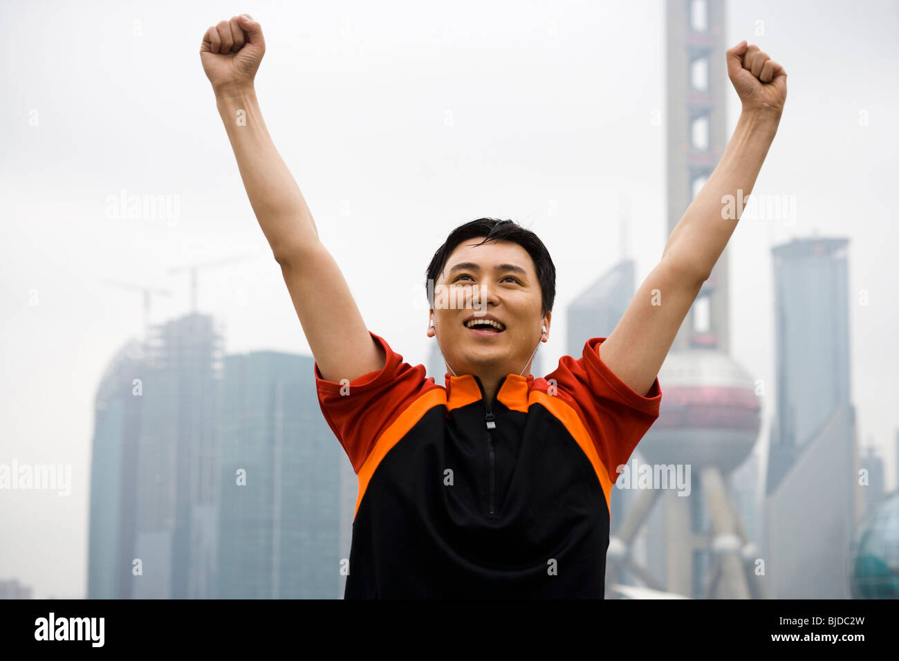 Man raising arms in the air Stock Photo - Alamy