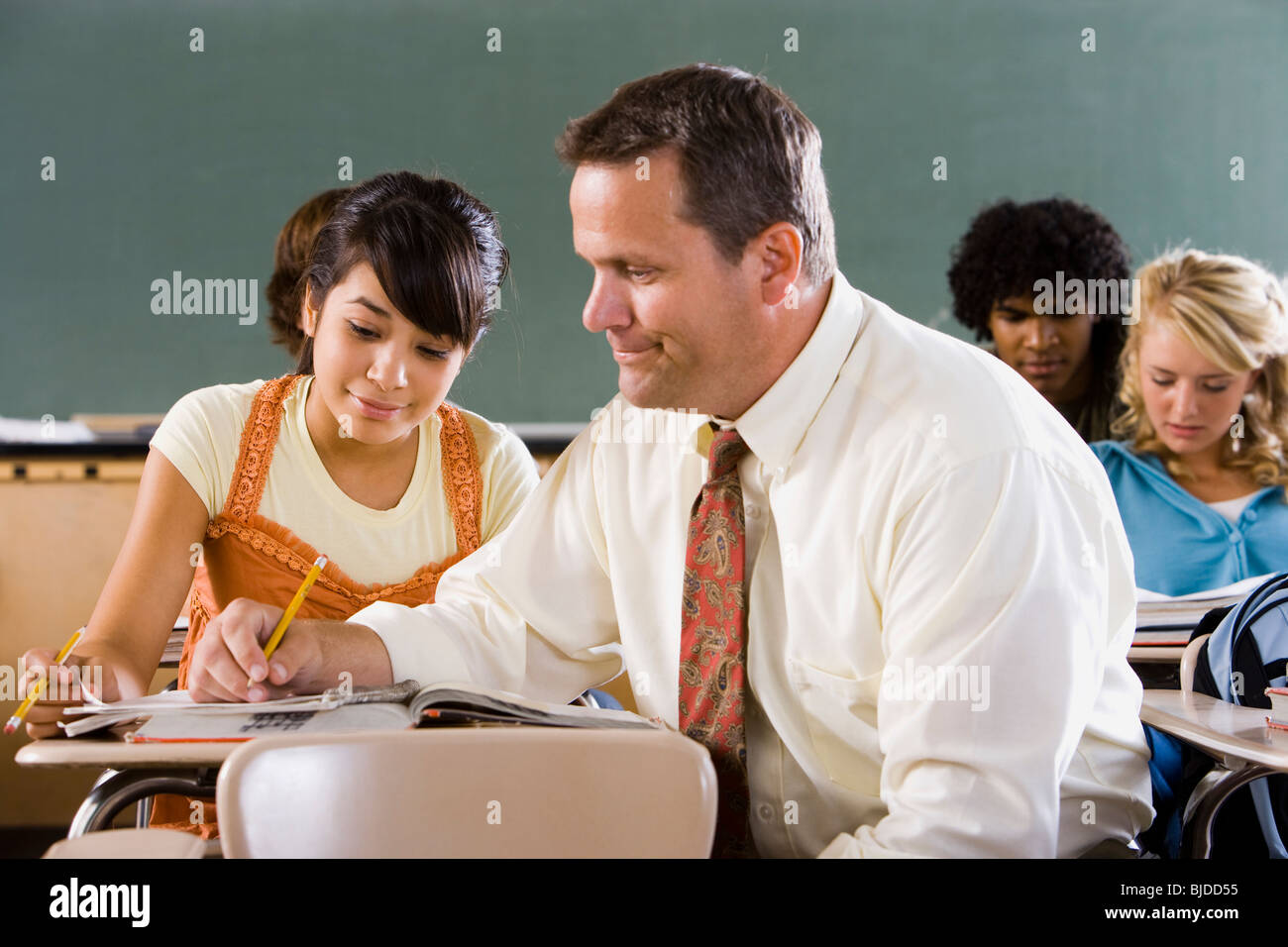 Student and teacher in a classroom Stock Photo - Alamy