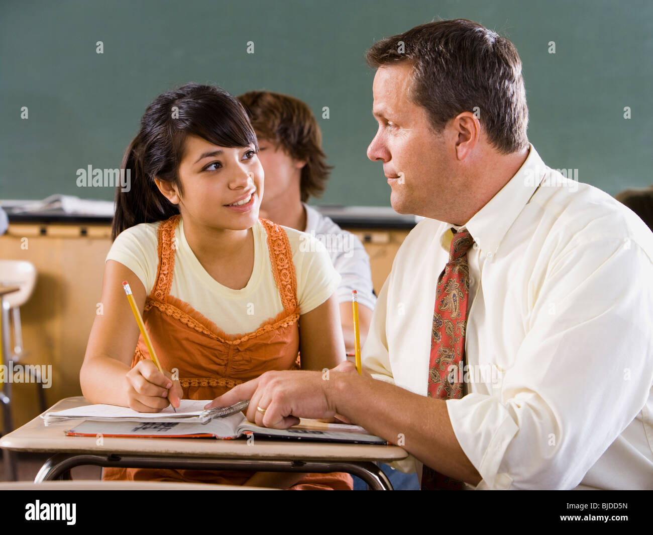 Student and teacher in a classroom Stock Photo - Alamy