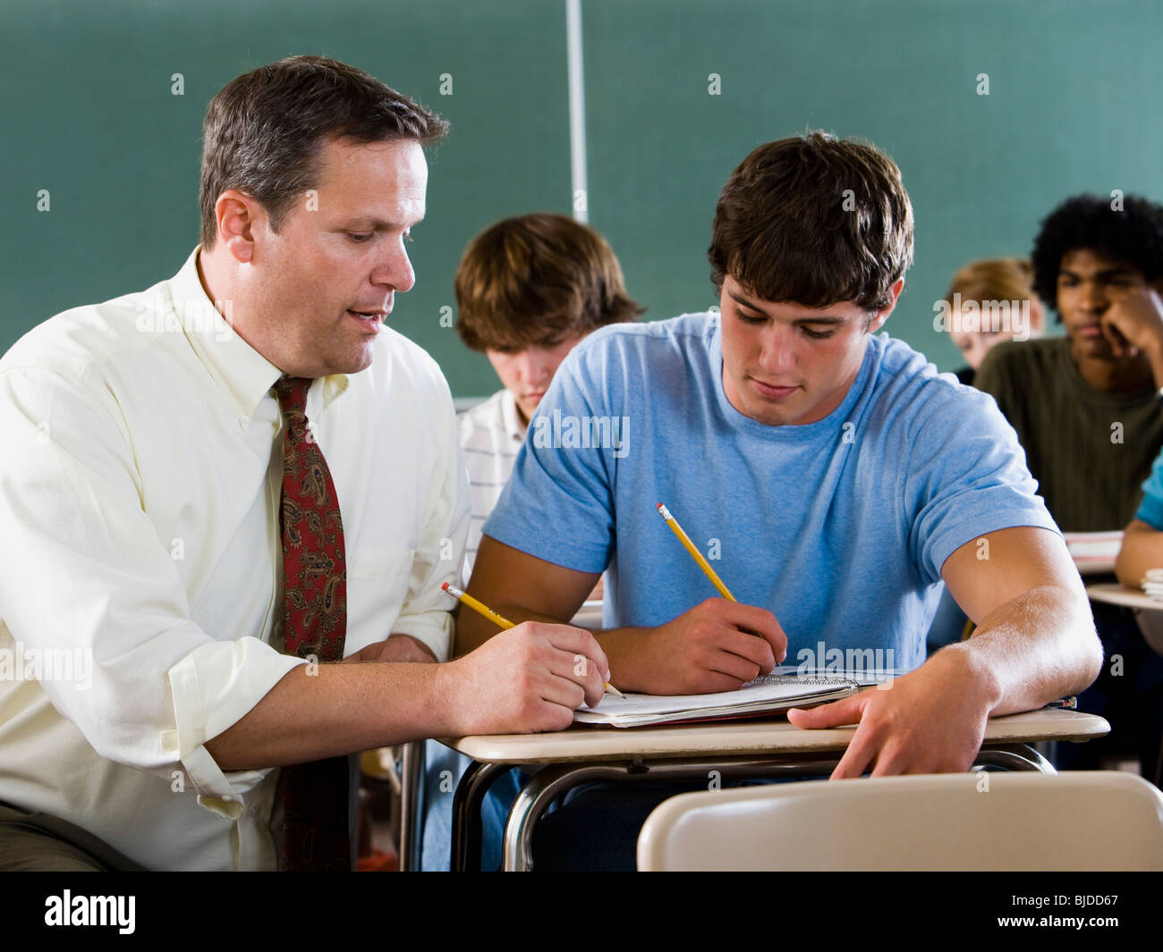 Student and teacher in a classroom Stock Photo - Alamy