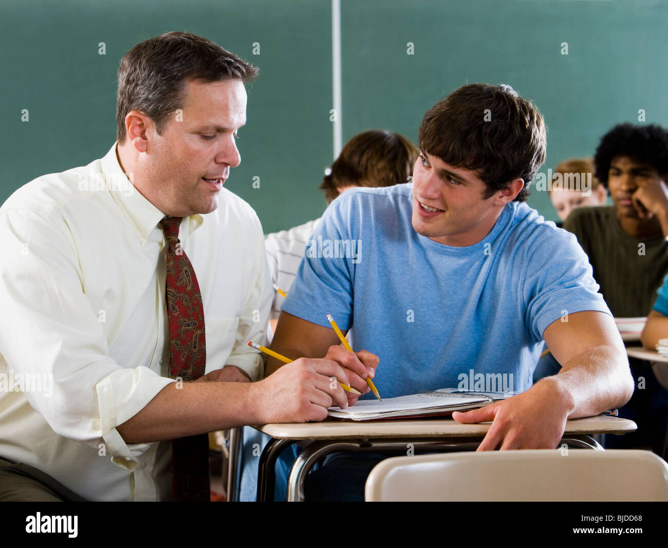 Student and teacher in a classroom Stock Photo - Alamy