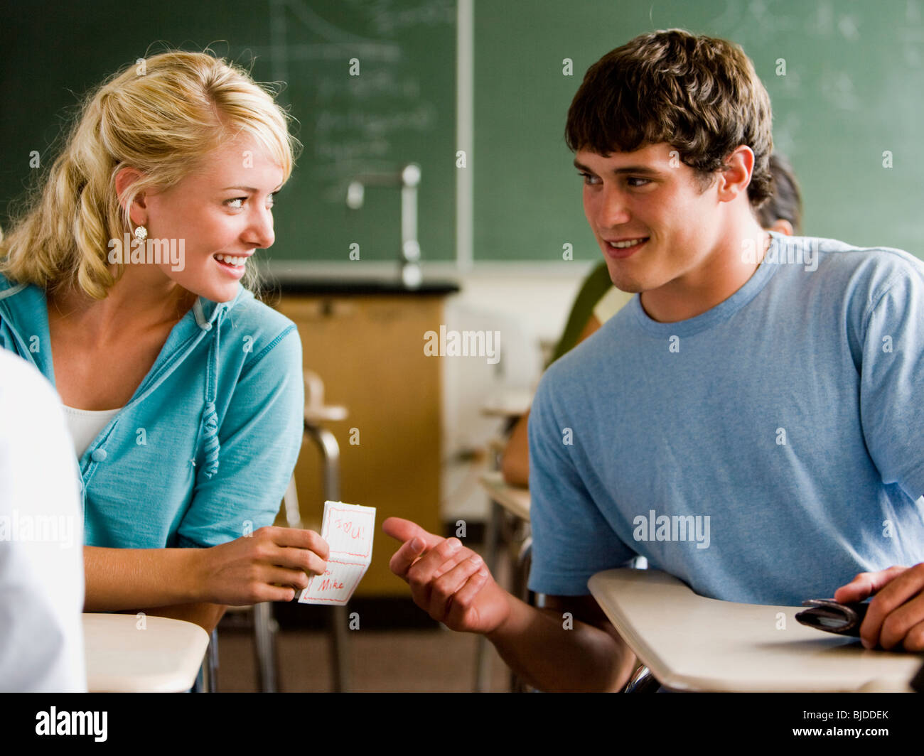 Students passing notes in a classroom Stock Photo - Alamy
