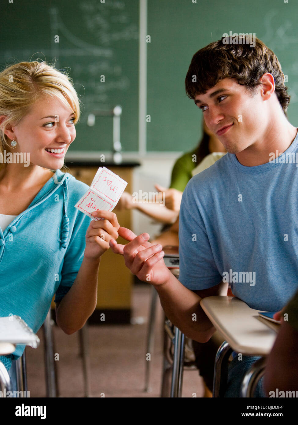 Students passing notes in a classroom Stock Photo - Alamy