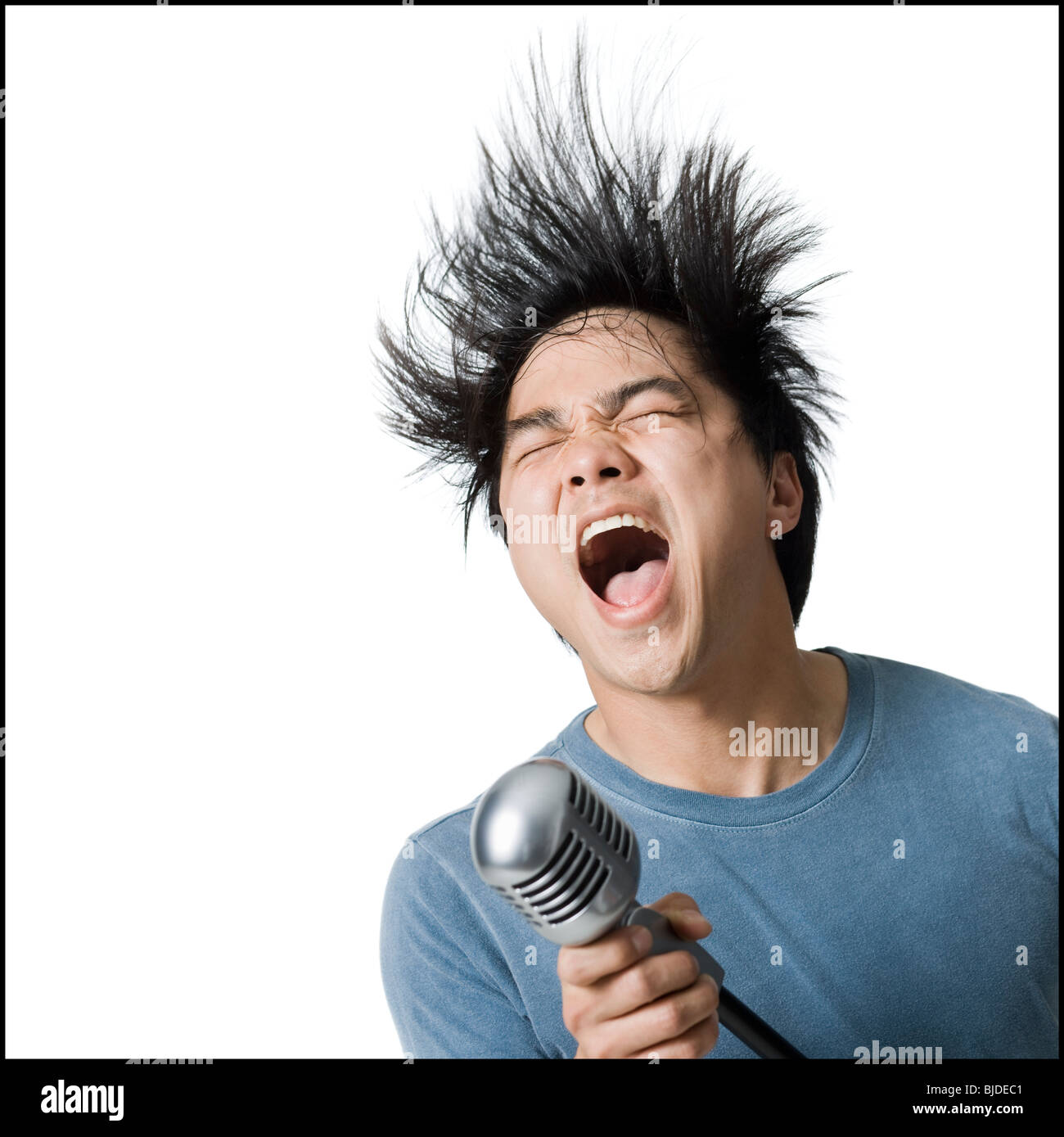 Man rocking out with mic stand Stock Photo - Alamy