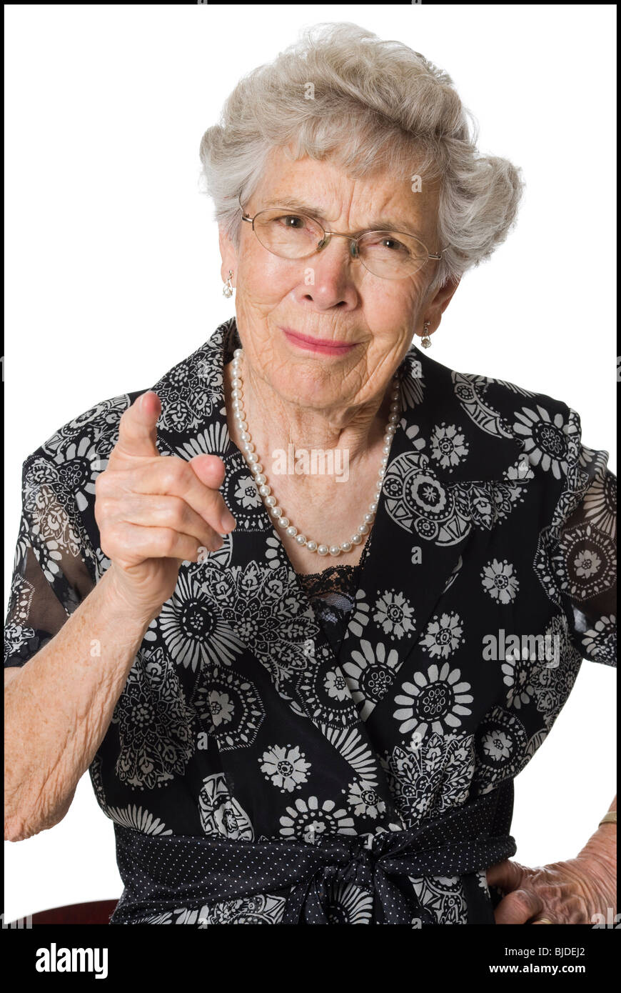 Senior woman with glasses looking sternly at camera Stock Photo - Alamy