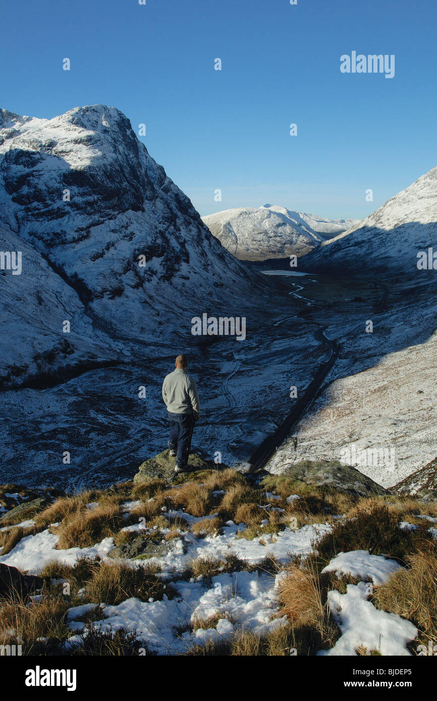 A walker looking along the Pass of Glencoe to Loch Achtriochtan from Am ...