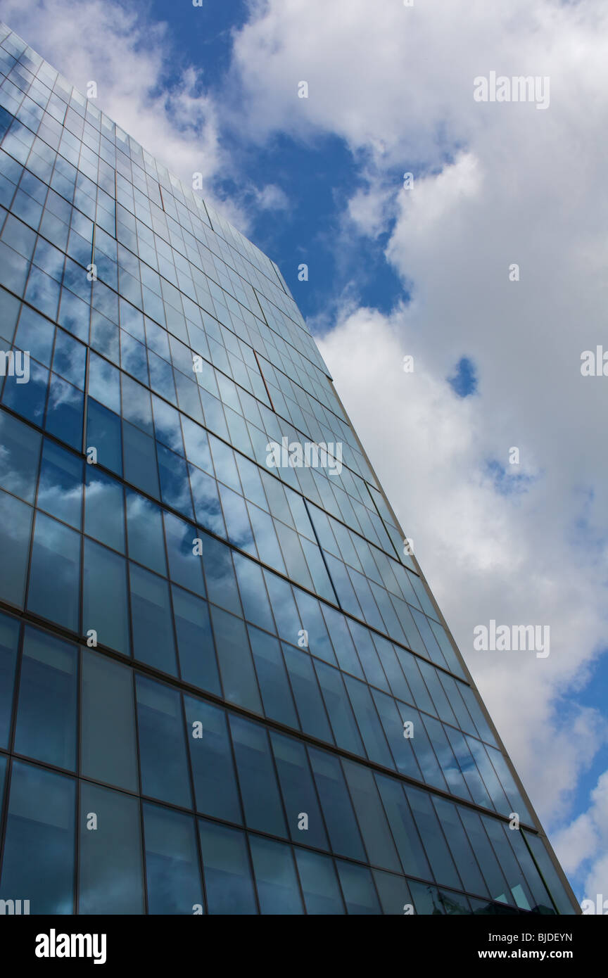 Vertical view of a Glass building in the city of london reflecting blue ...