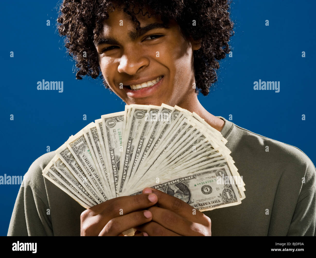 young man holding money Stock Photo - Alamy