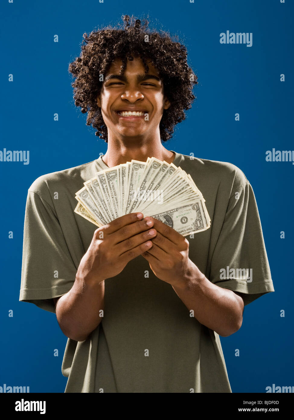 young man holding money Stock Photo - Alamy