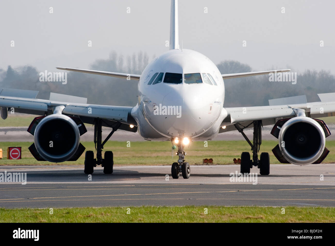 Airplane head on view on runway Stock Photo - Alamy