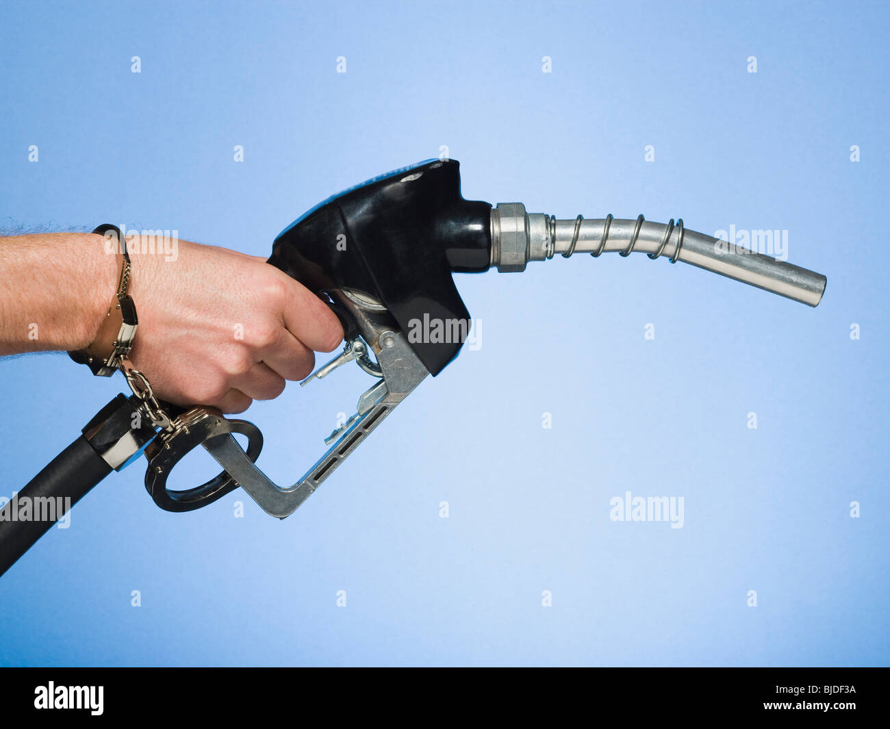 Hand handcuffed to a gas pump Stock Photo - Alamy