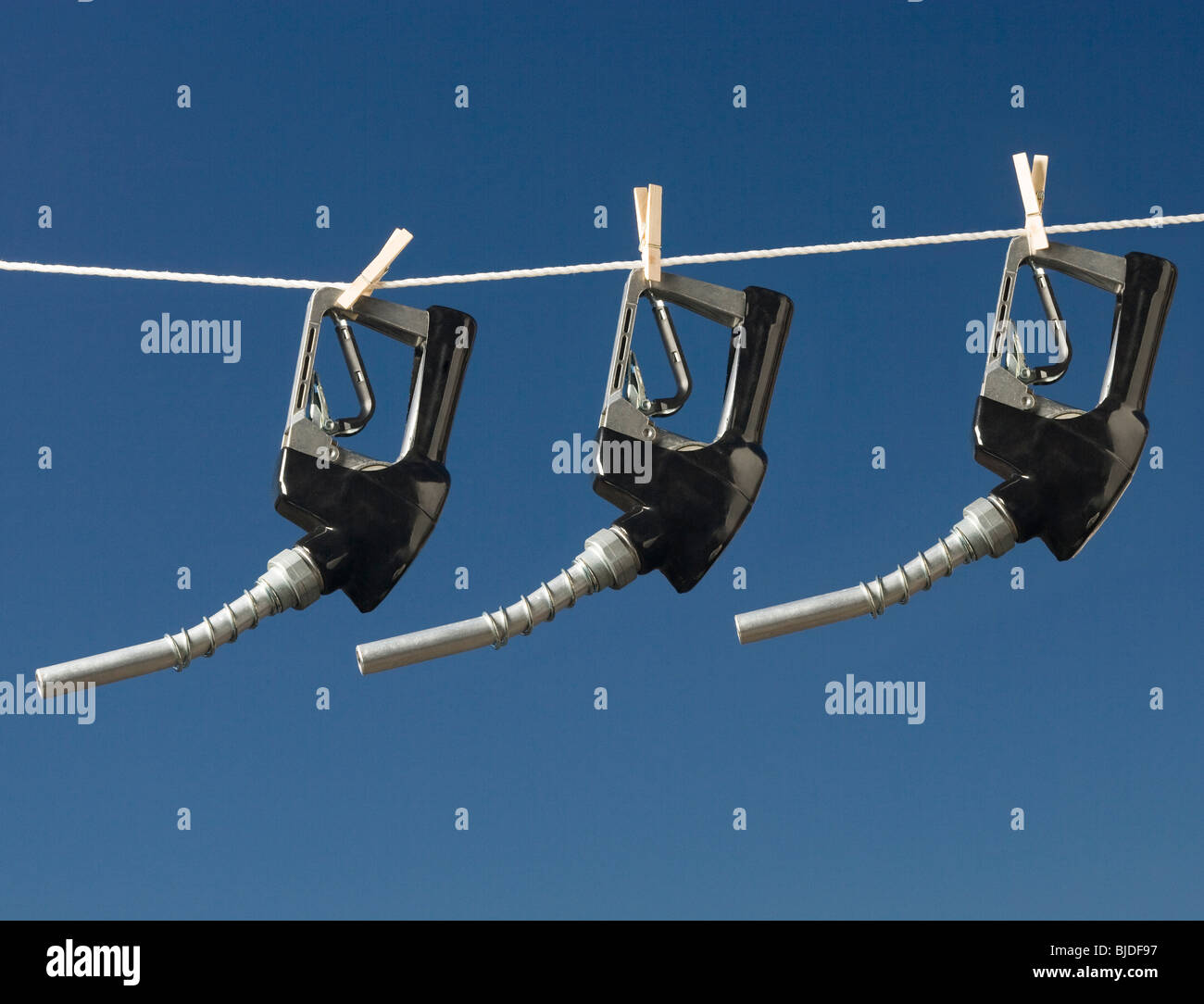Gas pump handles on a clothes line Stock Photo - Alamy