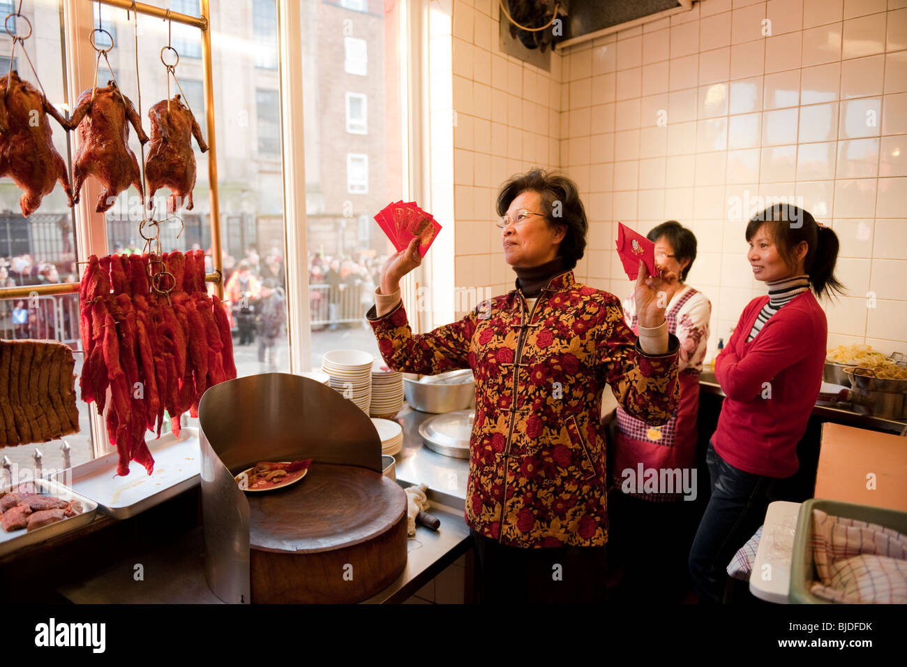 Chinese restaurant owner with red envelopes of money for Chinese New ...