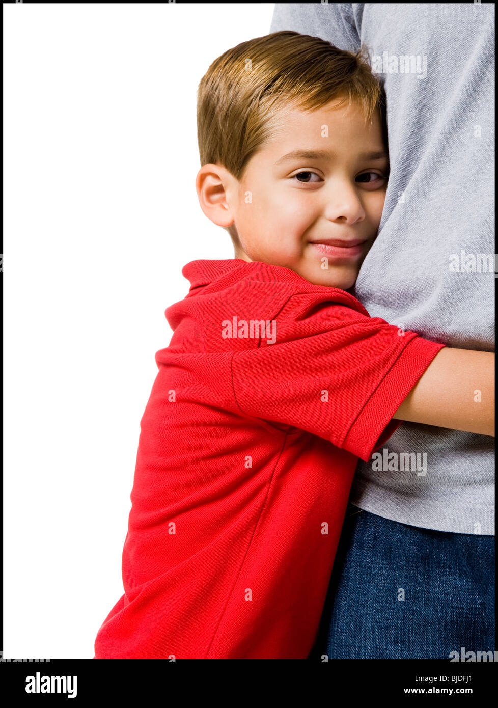 boy in a red shirt hugging a man Stock Photo - Alamy