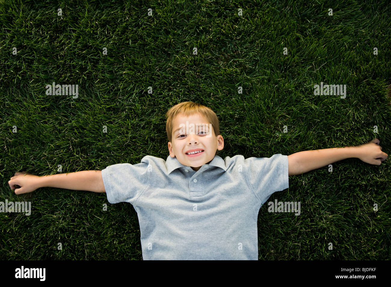 boy lying on the grass Stock Photo - Alamy