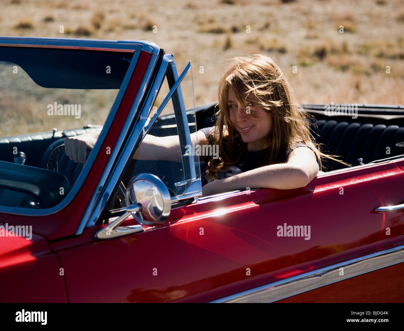 woman in a red convertible Stock Photo - Alamy