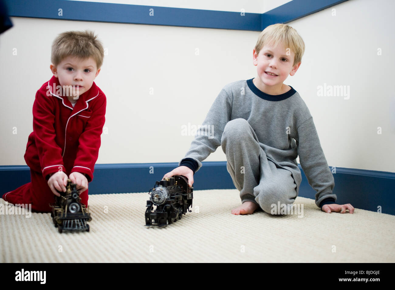 two boys playing wth toys Stock Photo - Alamy