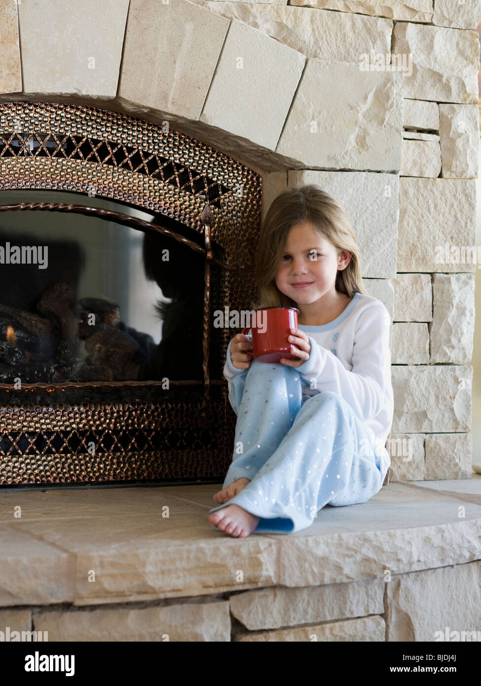 child in front of a fireplace Stock Photo - Alamy