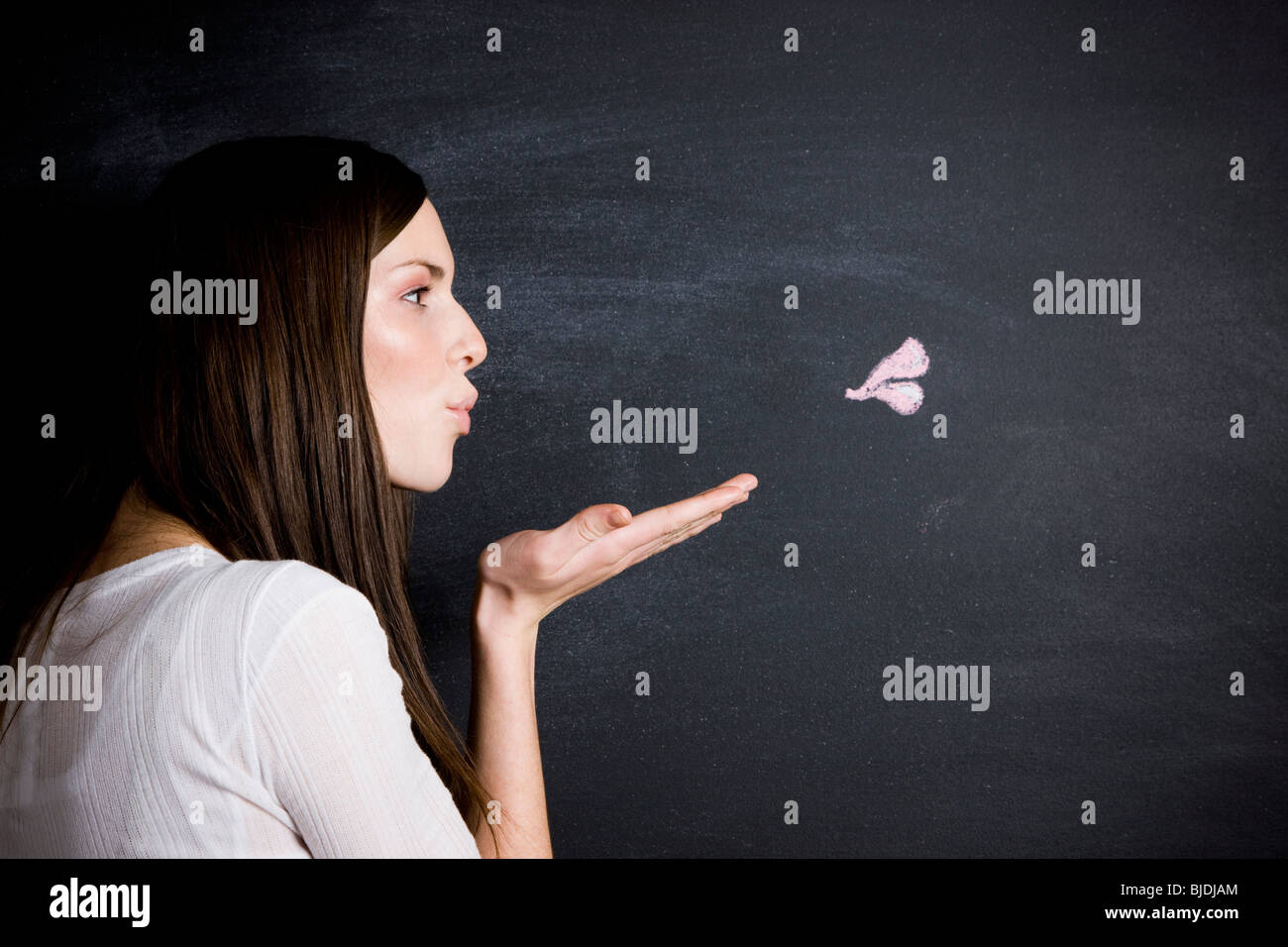 young woman against a chalkboard Stock Photo - Alamy