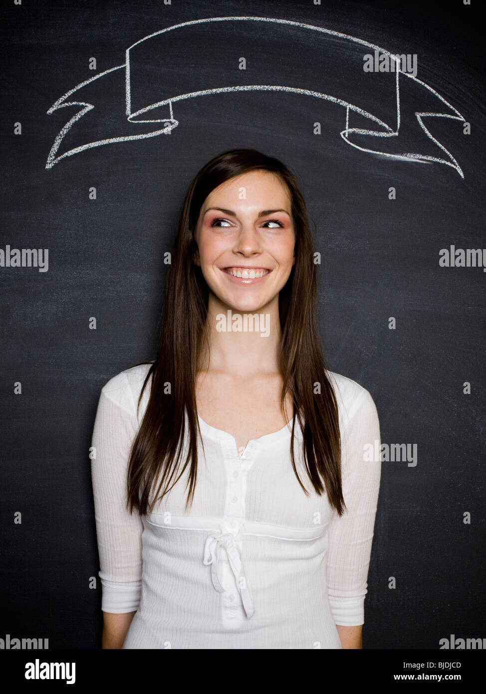 young woman against a chalkboard Stock Photo - Alamy
