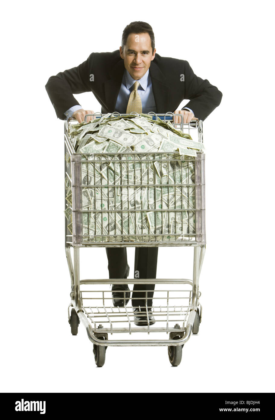 businessperson with a shopping cart full of money Stock Photo - Alamy