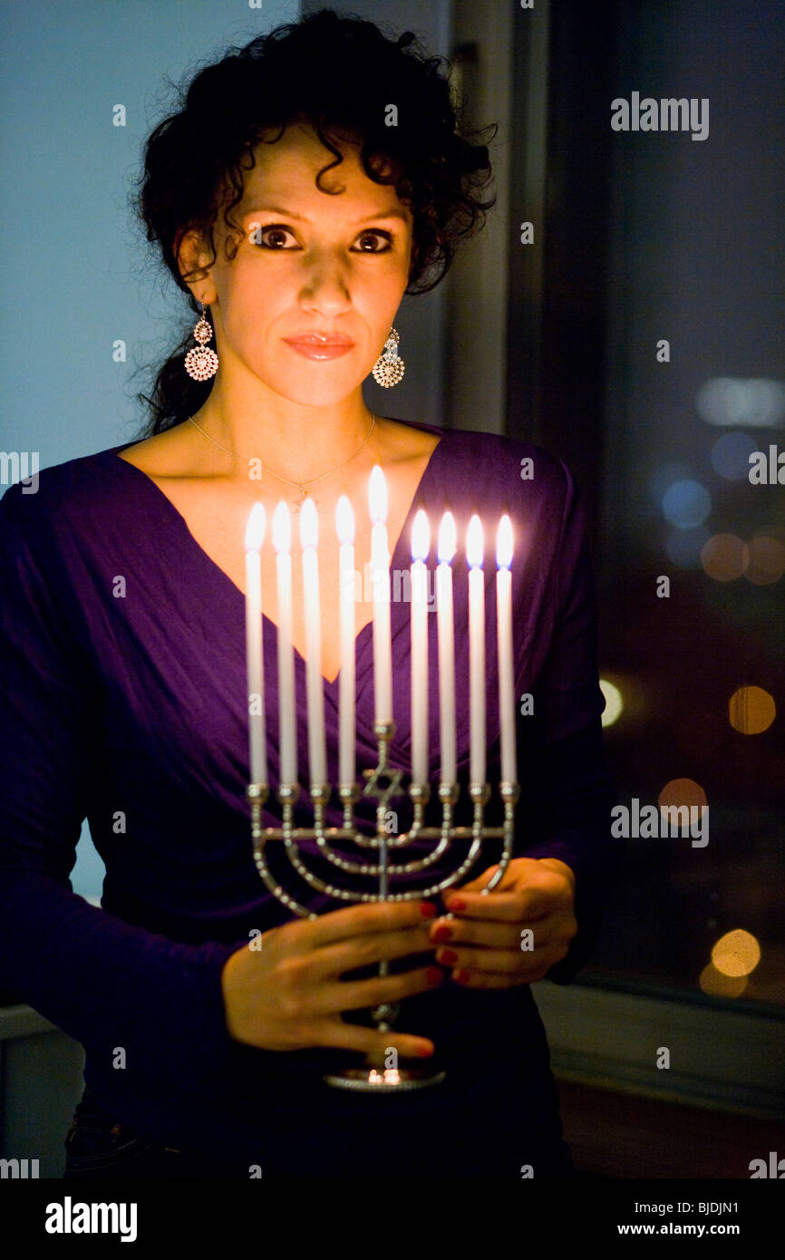 Woman with a menorah Stock Photo - Alamy