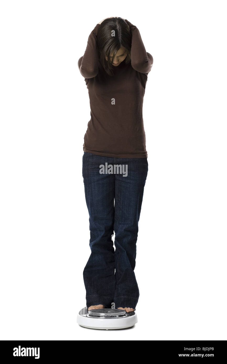Young girl on scales Cut Out Stock Images & Pictures - Alamy