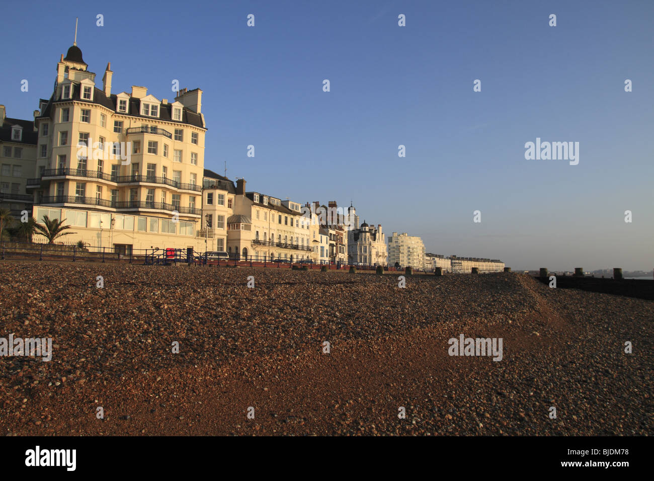 Looking East along Eastbourne Beach and seafront at sunrise with the ...