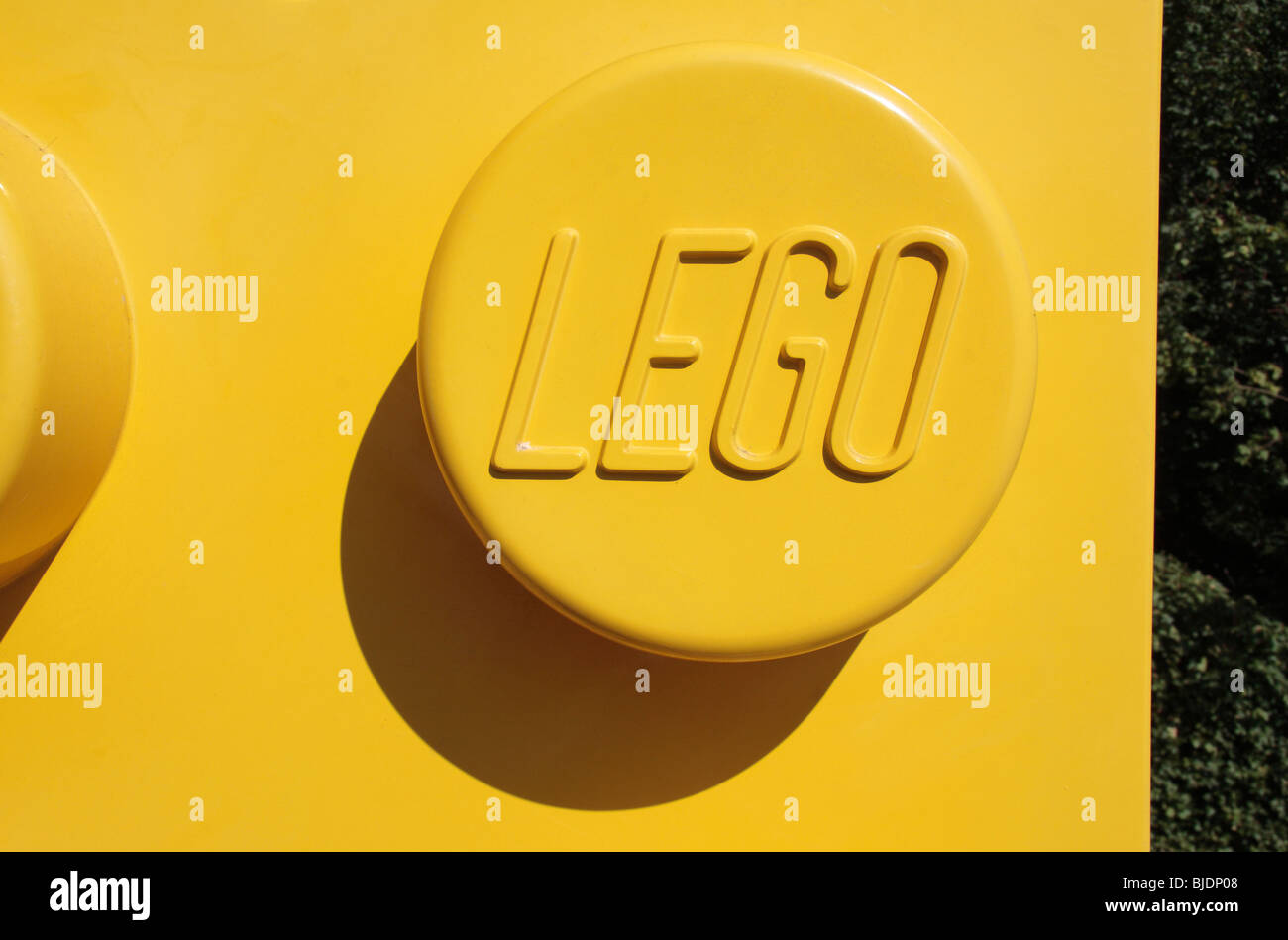 Close up of the Lego branding on a giant yellow Lego block outside ...