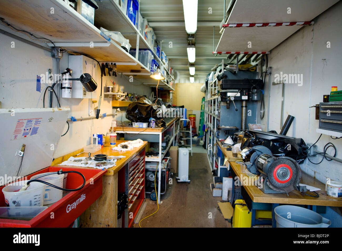 An improvised workshop built inside a shipping container. It is common ...