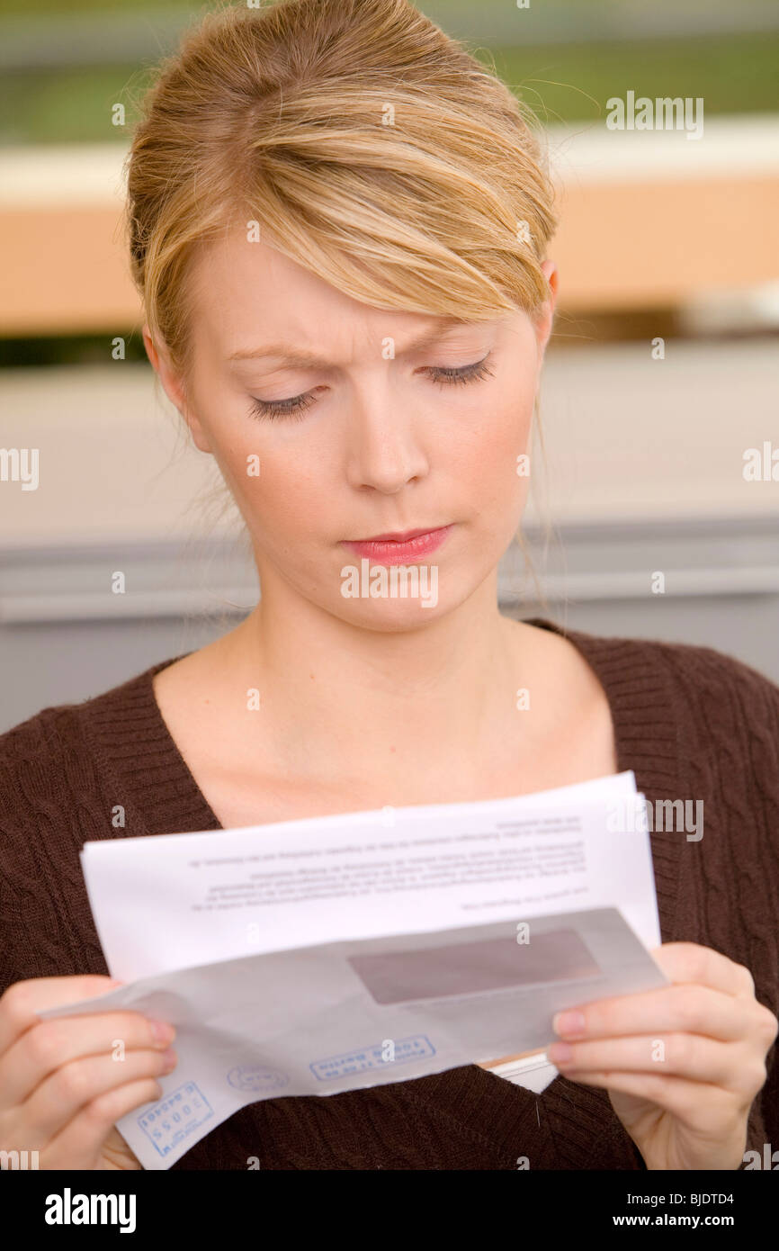 Woman reading letter not smiling hi-res stock photography and images ...