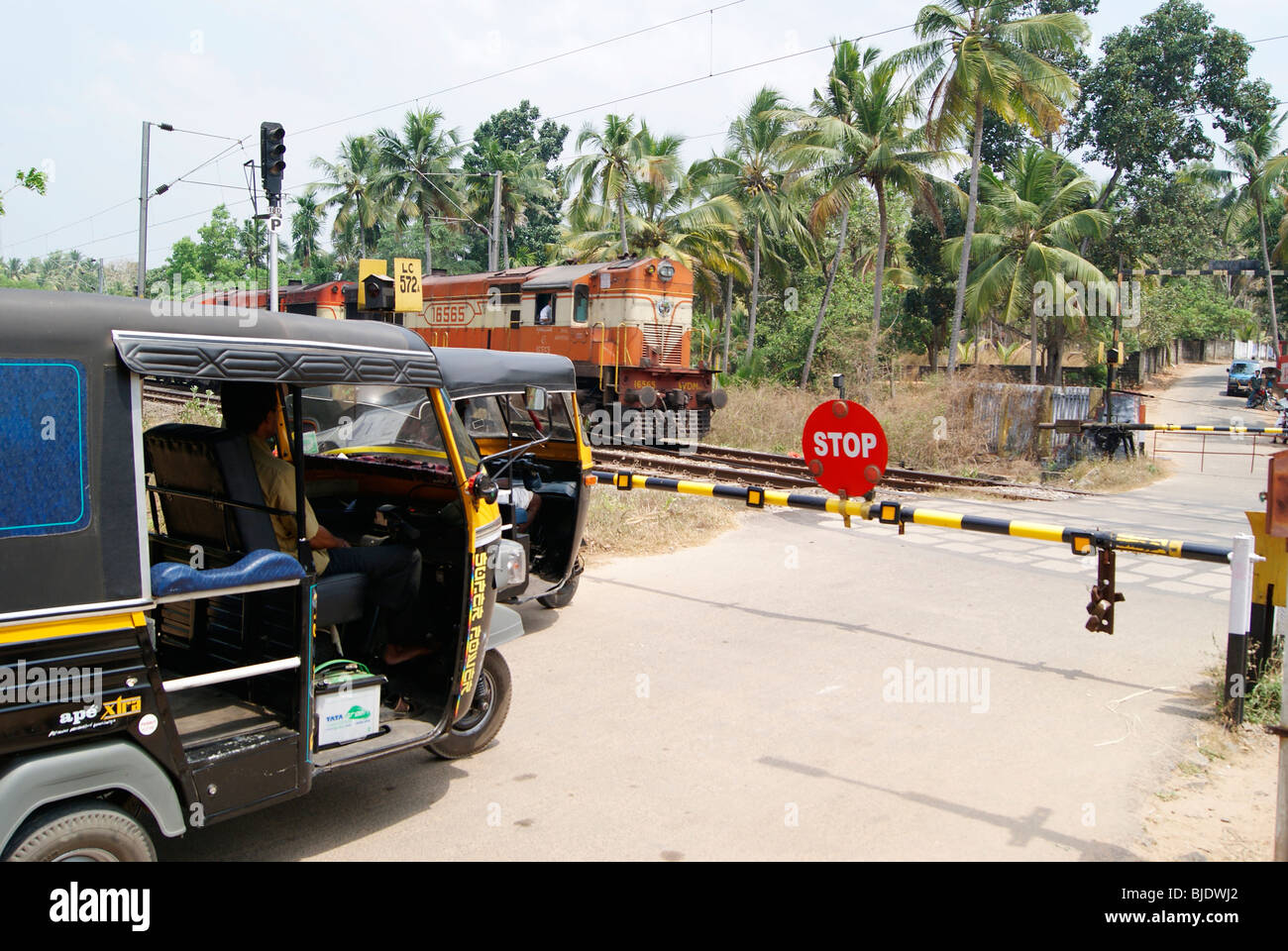 Auto Rickshaws waiting in the Railway cross for the passage of Electric ...