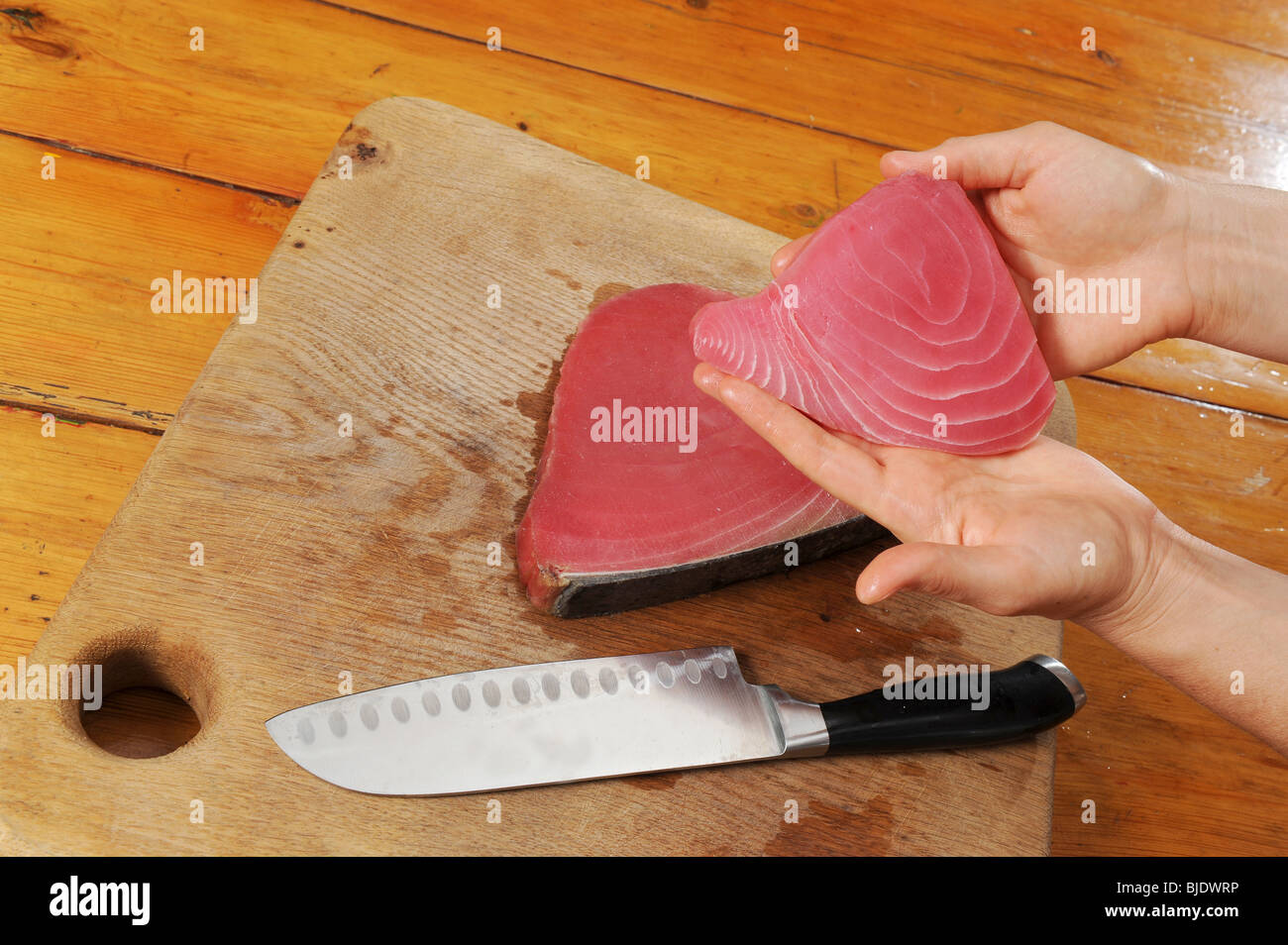 tuna being exposed by woman hands Stock Photo - Alamy