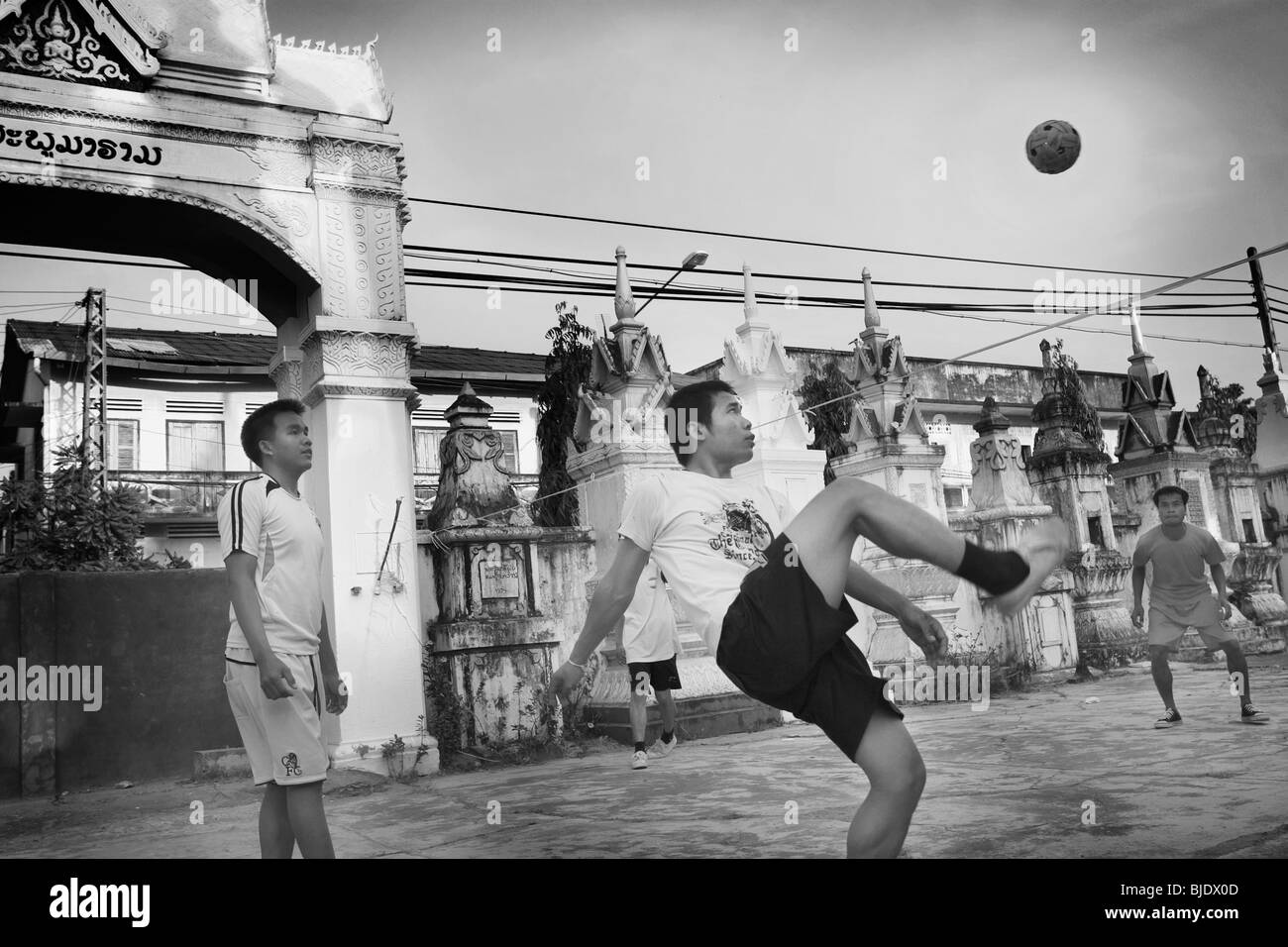 Young men play kataw, a game which combines elements of volleyball and ...