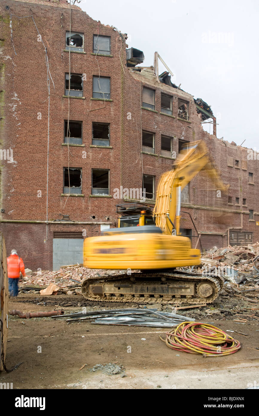 demolition squad destroy an old building to start a new development ...