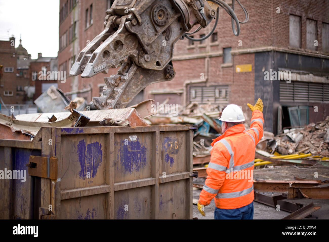 demolition squad destroy an old building to start a new development ...