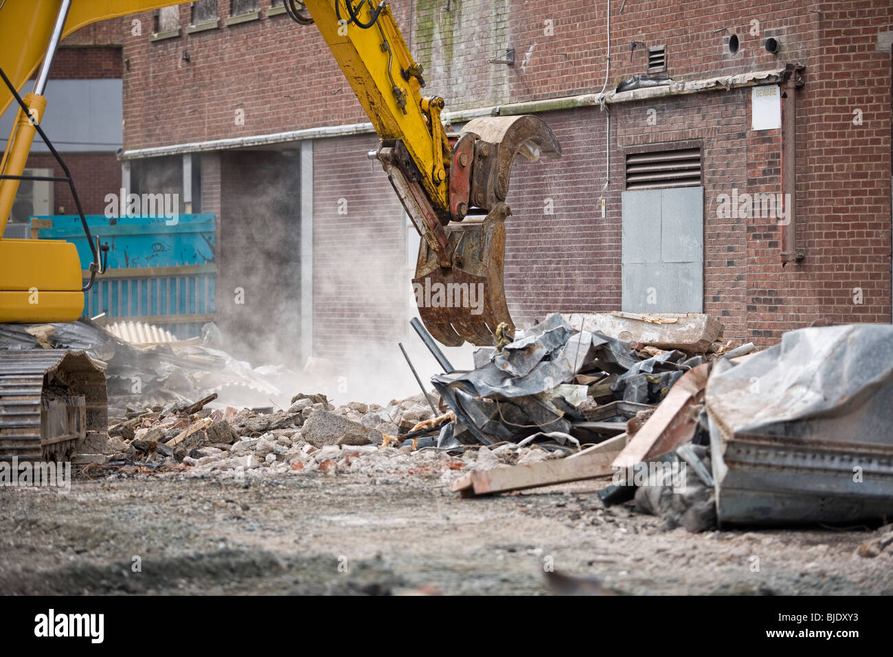 demolition squad destroy an old building to start a new development ...