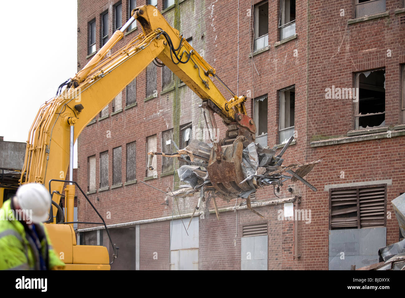 demolition squad destroy an old building to start a new development ...