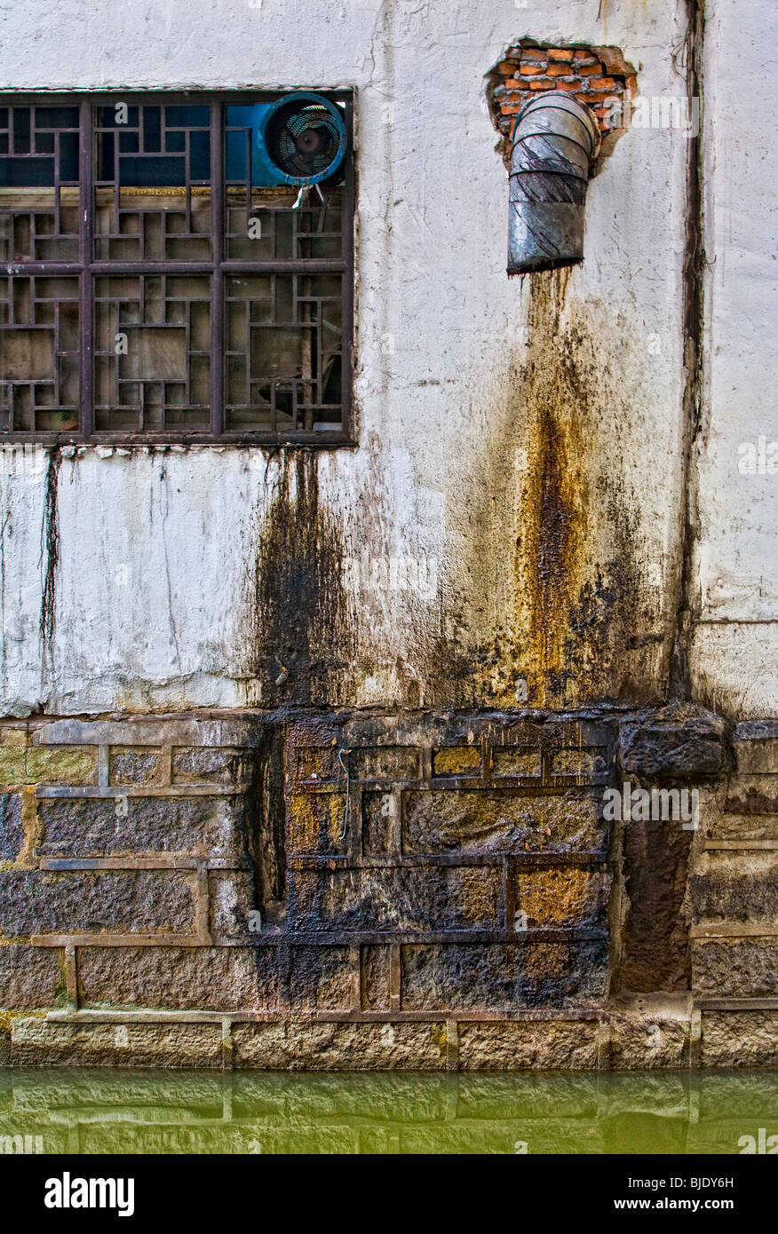 A Kitchen waste dumping pipe on a dirty wall, over the river Stock ...